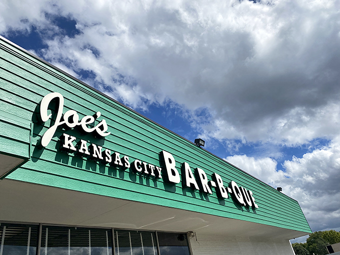 The iconic green exterior of Joe's Kansas City Bar-B-Que stands as a beacon of hope for hungry travelers—proof that extraordinary food often hides in ordinary places.
