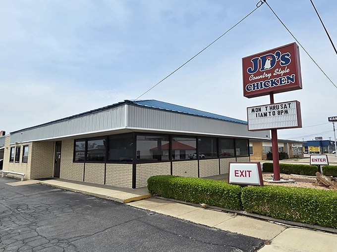 The iconic red and blue sign of J.D.'s Country Style Chicken stands as a beacon for hungry travelers along the highway in Hays, Kansas.