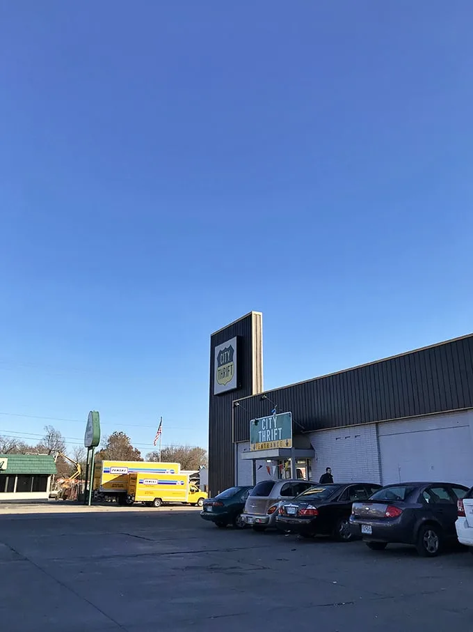 The iconic black and white exterior of City Thrift Waldo stands like a beacon for bargain hunters, complete with festive pennant flags that seem to whisper, "Treasures await inside!"