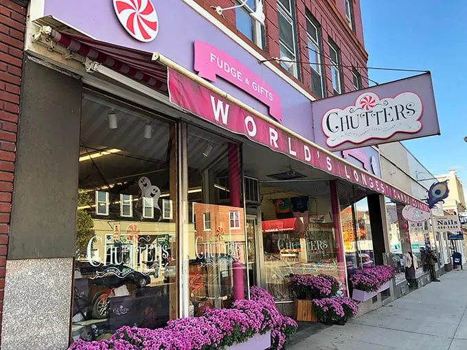 The iconic pink storefront of Chutters beckons like a sugary mirage on Littleton's Main Street. Those purple flowers aren't just decoration—they're a warning sign that willpower goes to die here.