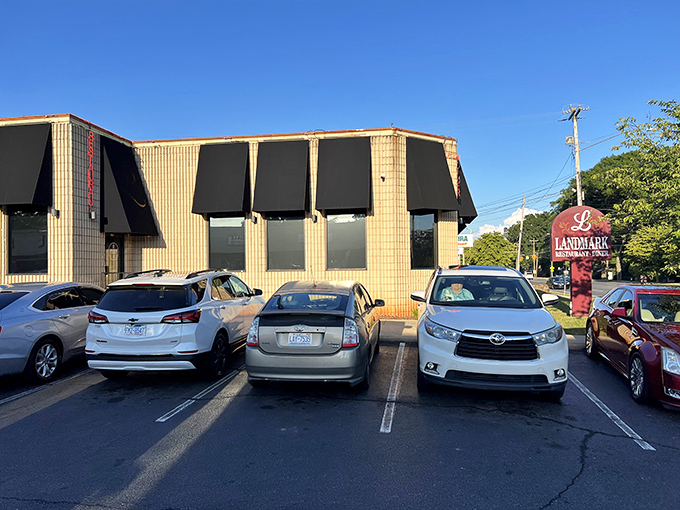 The unassuming exterior of Landmark Diner stands as Charlotte's culinary fortress – modest architecture hiding extraordinary flavors within.