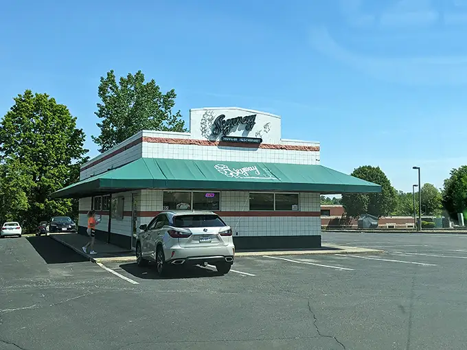 The white-tiled time machine with its signature green awning beckons hungry travelers. This isn't retro by design—it simply never stopped being wonderful.