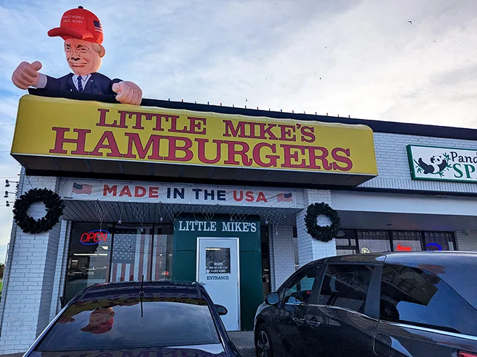 The bright yellow sign beckons like a burger lighthouse on the Oklahoma horizon. Nothing says "American classic" quite like that patriotic banner.