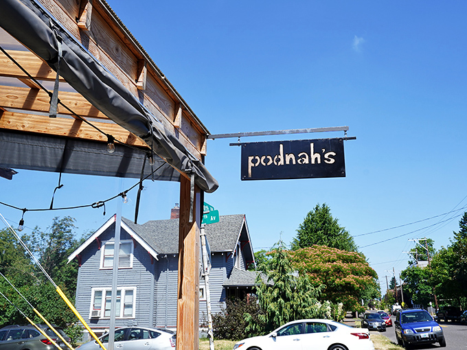 The entrance to barbecue nirvana, flanked by wood cages that aren't just decoration—they're the secret behind that intoxicating smoke aroma wafting through the neighborhood.