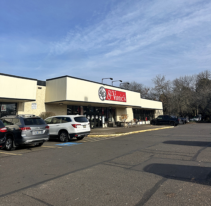 The iconic red St. Vinnie's storefront beckons like a siren call to treasure hunters. Even the lawn mowers outside are waiting for their second chance at greatness.
