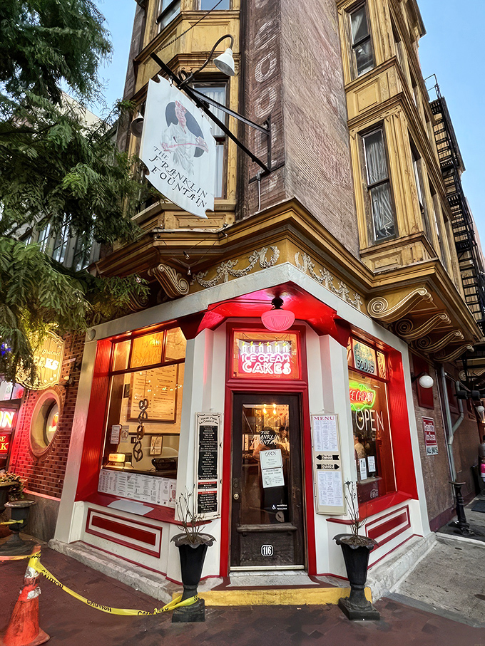 The storefront beckons like a time portal to ice cream's golden age—ornate yellow cornice, classic signage, and that brick facade promising sweet nostalgia inside.