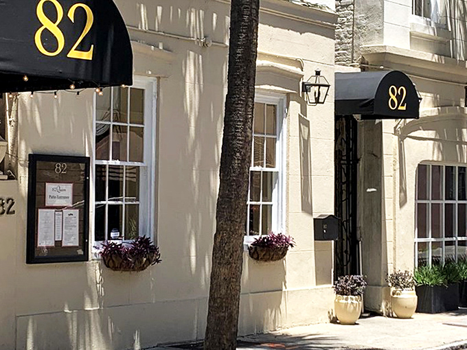 The courtyard at 82 Queen feels like Charleston's best-kept secret—a lush oasis where palm fronds and wrought-iron chairs conspire to make time slow down deliciously.