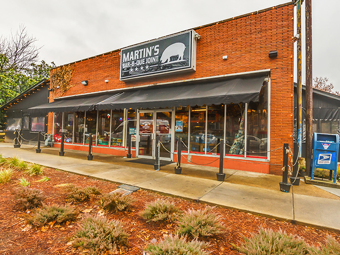 The red brick exterior of Martin's Bar-B-Que Joint beckons hungry pilgrims with its no-nonsense façade and the promise of smoky delights within.