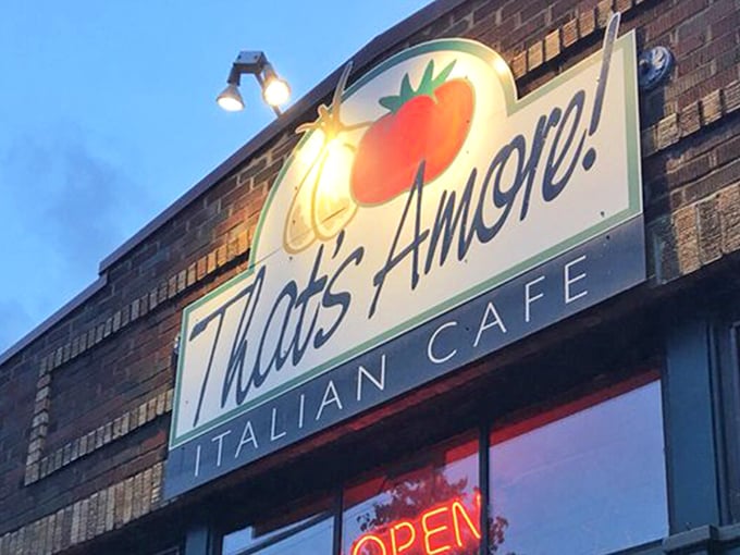 That neon tomato sign isn't just winking at you—it's inviting you into a brick-fronted paradise where pasta dreams come true.