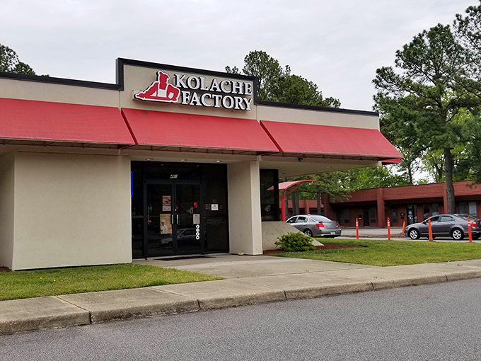 The bright red awning of Kolache Factory stands out like a culinary lighthouse, beckoning carb enthusiasts to discover Czech-inspired delights inside.