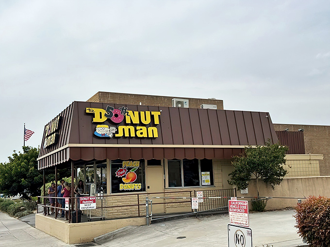 The humble roadside stand with its iconic yellow sign sits against the San Gabriel Mountains like a sweet oasis on Route 66.