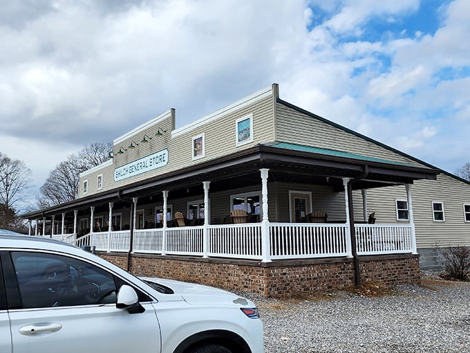 The welcoming facade of Shiloh General Store stands proudly against a brilliant blue North Carolina sky, its wide porch practically whispering "slow down and stay awhile."