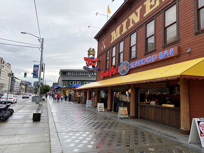 The iconic red crab sign beckons seafood lovers like a crustacean lighthouse on Seattle's waterfront, promising maritime delights within the rustic wooden building.