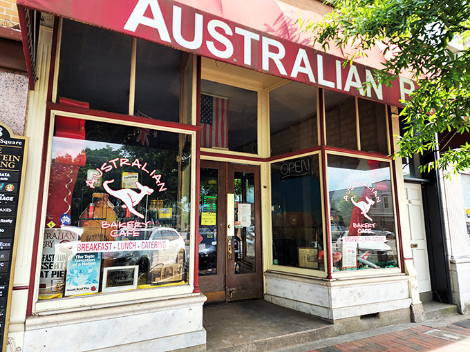 The red awning beckons like a culinary lighthouse on Marietta Square, promising authentic Down Under delights that'll make you forget you're in Georgia.