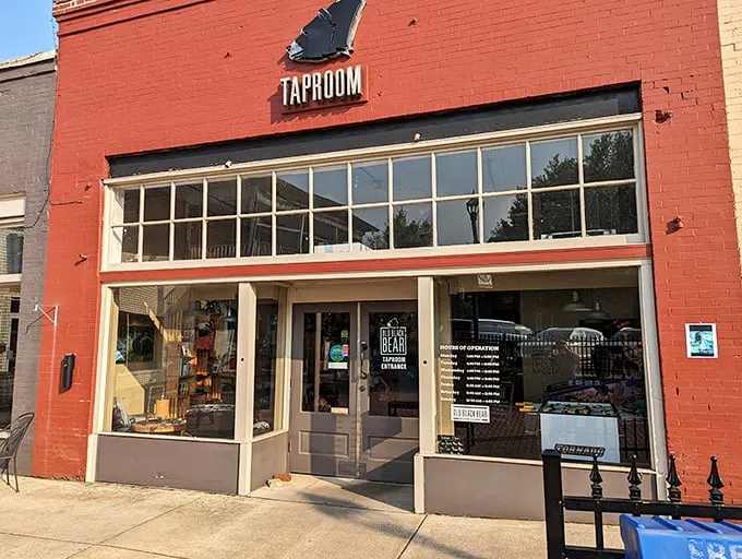 The bright red brick exterior of Old Black Bear's taproom stands as a beacon of culinary promise in historic downtown Madison.