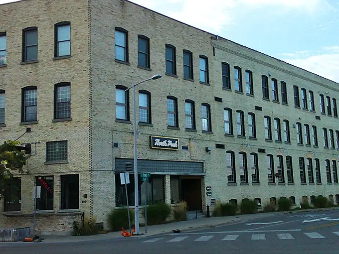 The historic brick façade of North Peak Brewing Company stands proud on Front Street, a Traverse City landmark that's been reinvented as a temple to craft beverages and comfort food.