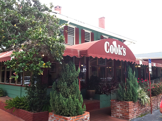 The green building with cherry-red awnings stands like a time capsule of comfort food dreams. Florida's culinary equivalent of finding a $20 bill in your winter coat.
