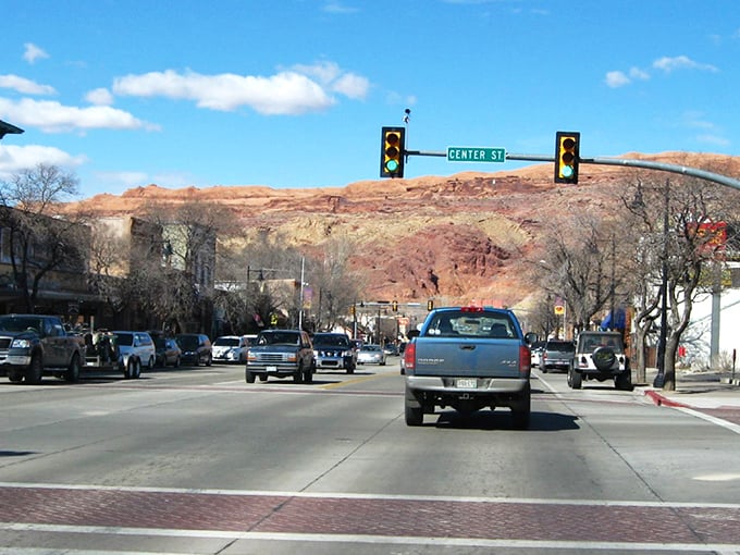 Main Street Moab, where pickup trucks are the fashion statement and those red rock backdrops aren't painted—Mother Nature just showing off.