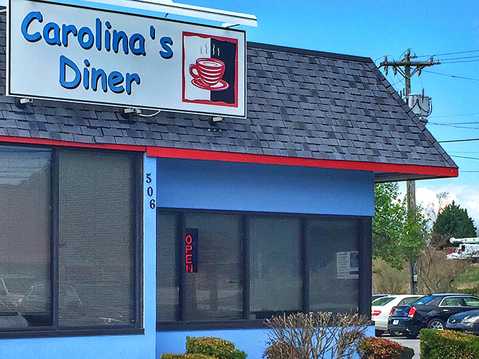 The distinctive blue exterior of Carolina's Diner stands as a beacon of breakfast hope along Regional Road, promising comfort food salvation inside.