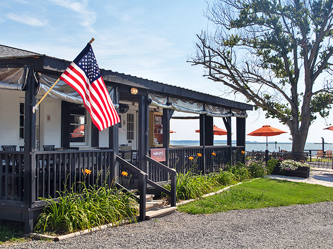 Merroir's unassuming exterior belies the culinary magic within. Those orange umbrellas aren't just for shade—they're beacons guiding seafood pilgrims to paradise.