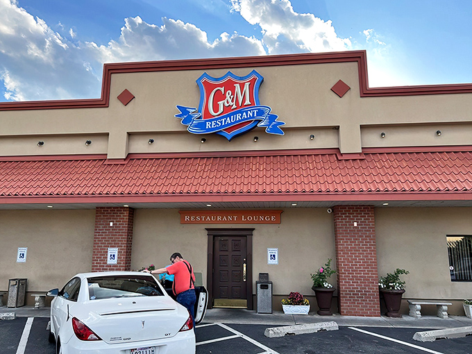 The iconic blue and red G&M sign welcomes seafood pilgrims like a maritime lighthouse, guiding hungry travelers to crab cake nirvana.