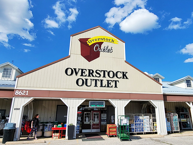 The unassuming barn-style exterior of Overstock Outlet promises treasure within—like finding a secret gold mine disguised as a humble homestead.