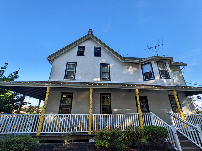The unassuming white farmhouse exterior of Lettie's Kitchen stands like a culinary time capsule, complete with the guardian rooster statue announcing "serious chicken business happens here."