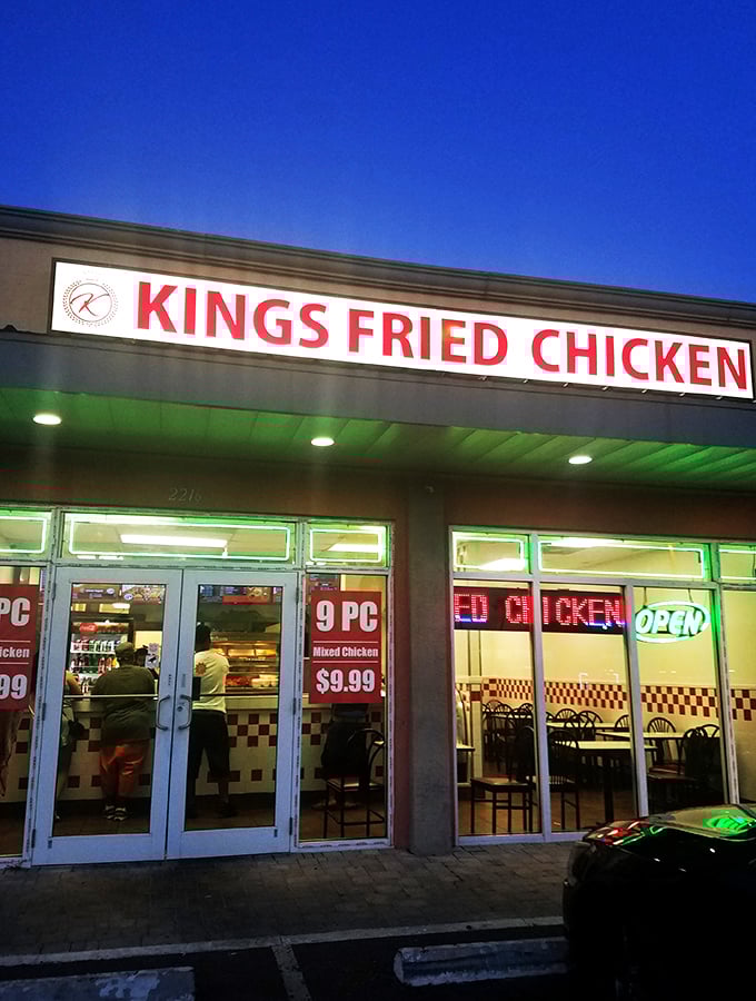 The bright yellow facade with bold red lettering stands as a no-nonsense declaration: this place means serious business when it comes to fried chicken.