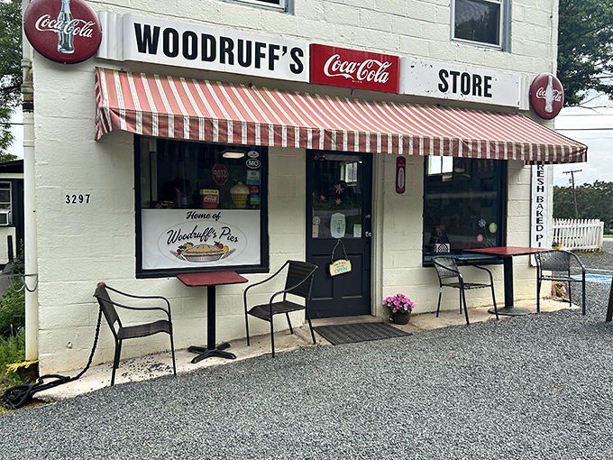 The classic red-and-white striped awning and vintage Coca-Cola signs aren't retro decoration—they're authentic pieces of Woodruff's history as a former general store.