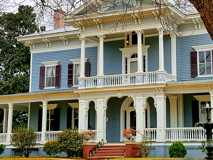 The stately blue Victorian façade of Elmwood 1820 stands proudly with its white columns and wrap-around porch, beckoning visitors to slow down and stay awhile.