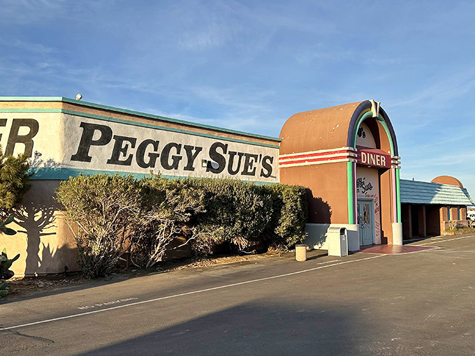 The rainbow-colored archway of Peggy Sue's beckons like a time portal in the desert. This isn't just a pit stop—it's a destination. 