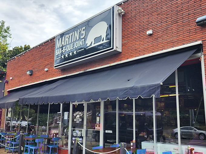 The red brick exterior of Martin's Bar-B-Que Joint beckons hungry pilgrims with its no-nonsense façade and the promise of smoky delights within.