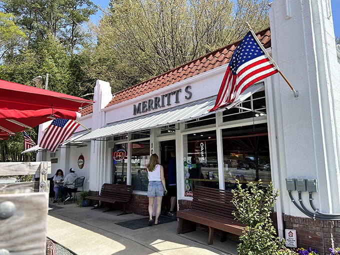The unassuming white building with American flags proudly waving says it all: great food doesn't need fancy architecture, just perfect execution.