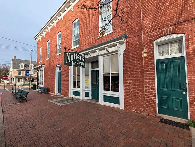 The historic red brick façade of Nutter's stands like a sweet sentinel on Sharpsburg's main street, beckoning ice cream lovers with timeless charm.