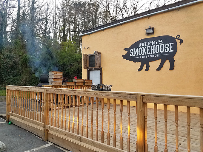 The unassuming beige façade with pink patio umbrellas says it all - true barbecue legends don't need fancy exteriors, just a good smoker and a pig sign.
