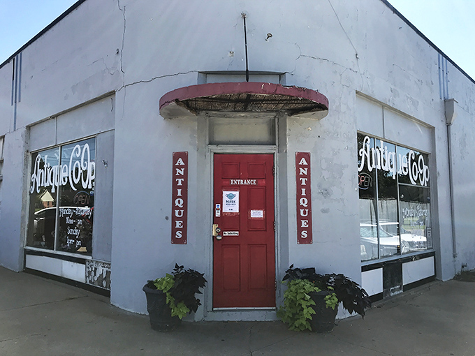 The unassuming white exterior with that iconic red door is like a portal to another dimension—one where time slows down and treasures await.
