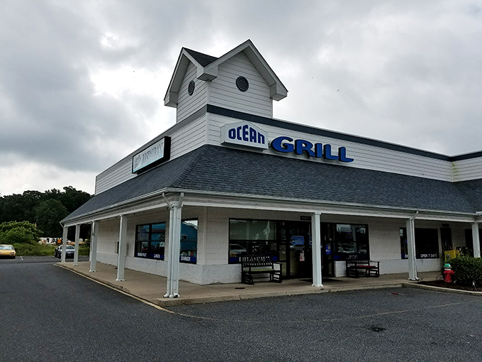 The white clapboard exterior of Ocean Grill stands like a beacon of comfort food promise. Those nautical round windows aren't just for show—they're portals to flavor town.