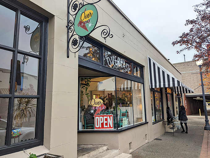 The storefront beckons with its simple charm—black door, striped awning, and outdoor seating that whispers, "Come in, the eggs are waiting." 