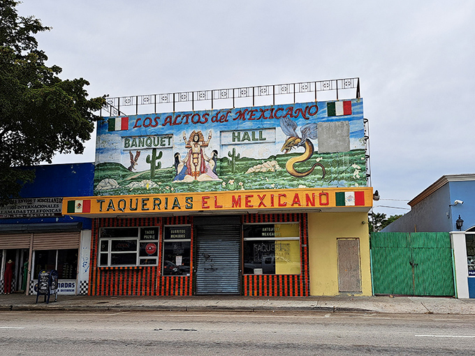 The vibrant mural above Taquerias El Mexicano isn't just decoration—it's a promise of the authentic flavors waiting inside this Little Havana landmark.