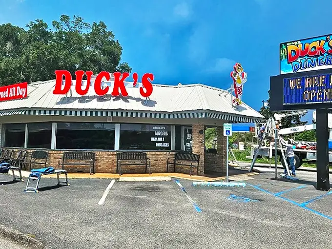 The bright red "DUCK'S" sign stands out like a breakfast lighthouse, guiding hungry souls to this Gulf Shores sanctuary of morning delights.
