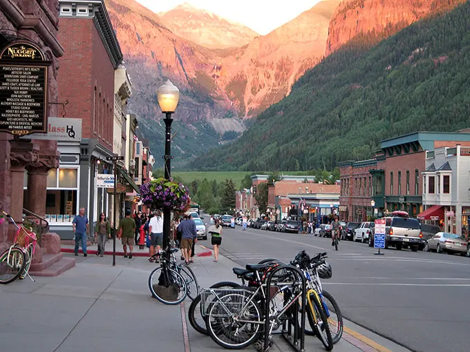 Colorado Avenue stretches toward mountain majesty, where Victorian charm meets alpine grandeur. Telluride's main street invites you to wander and wonder.
