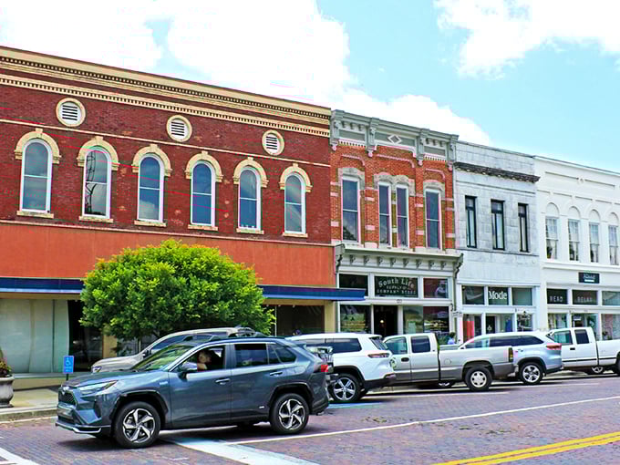 Thomasville's historic downtown facades stand like colorful sentinels of bygone eras, where modern cars park alongside timeless architecture.
