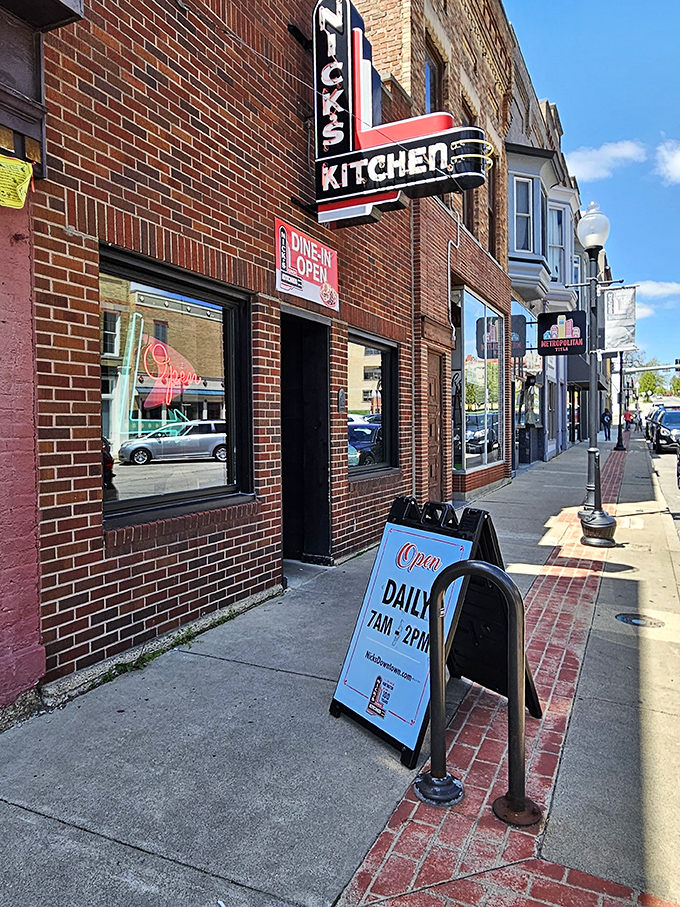 The iconic neon sign of Nick's Kitchen stands as a beacon of culinary history on Huntington's Jefferson Street. A century of tenderloin tradition lives behind this brick façade.
