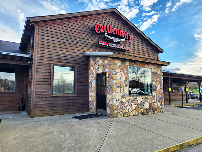 The rustic wooden exterior of Cattleman's Roadhouse beckons like an old friend, promising comfort and satisfaction within those stone-accented walls.