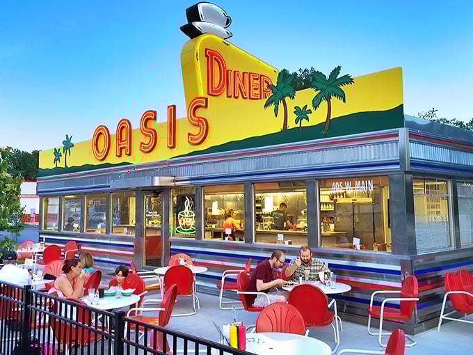 The sunshine-yellow facade of Oasis Diner gleams like a beacon of hope for hungry travelers. This isn't just a restaurant—it's a time machine with french fries.