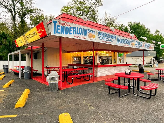 Lou's iconic red-roofed stand beckons like a neon-lit time machine, promising tenderloins and nostalgia in equal measure.