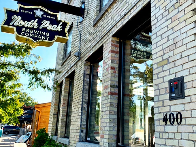 The historic brick façade of North Peak Brewing Company stands proud on Front Street, a Traverse City landmark that's been reinvented as a temple to craft beverages and comfort food.