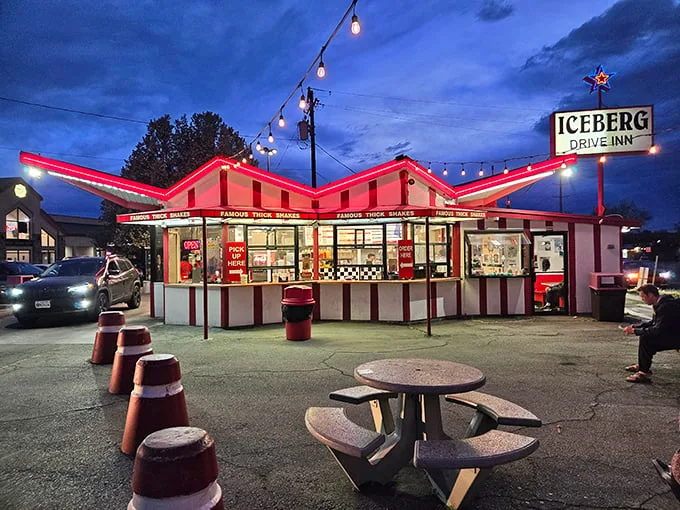 The iconic red and white striped exterior of Iceberg Drive Inn stands like a time capsule on 3900 South, promising nostalgic delights within.