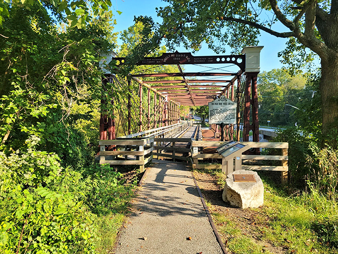 The historic Bollman Truss Bridge stands as an iron sentinel over time, its burgundy framework a perfect backdrop for selfies that'll make your Facebook friends jealous.
