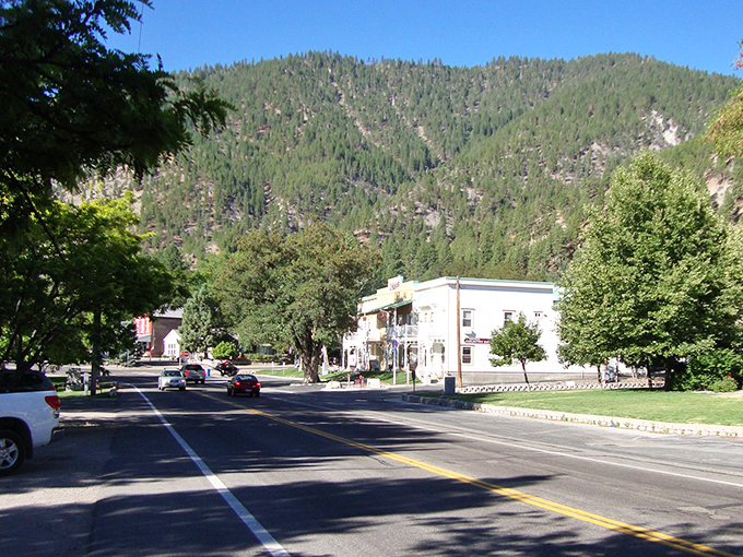 Genoa's main street offers that perfect small-town tableau – historic buildings nestled against mountains so majestic they look like they're showing off.